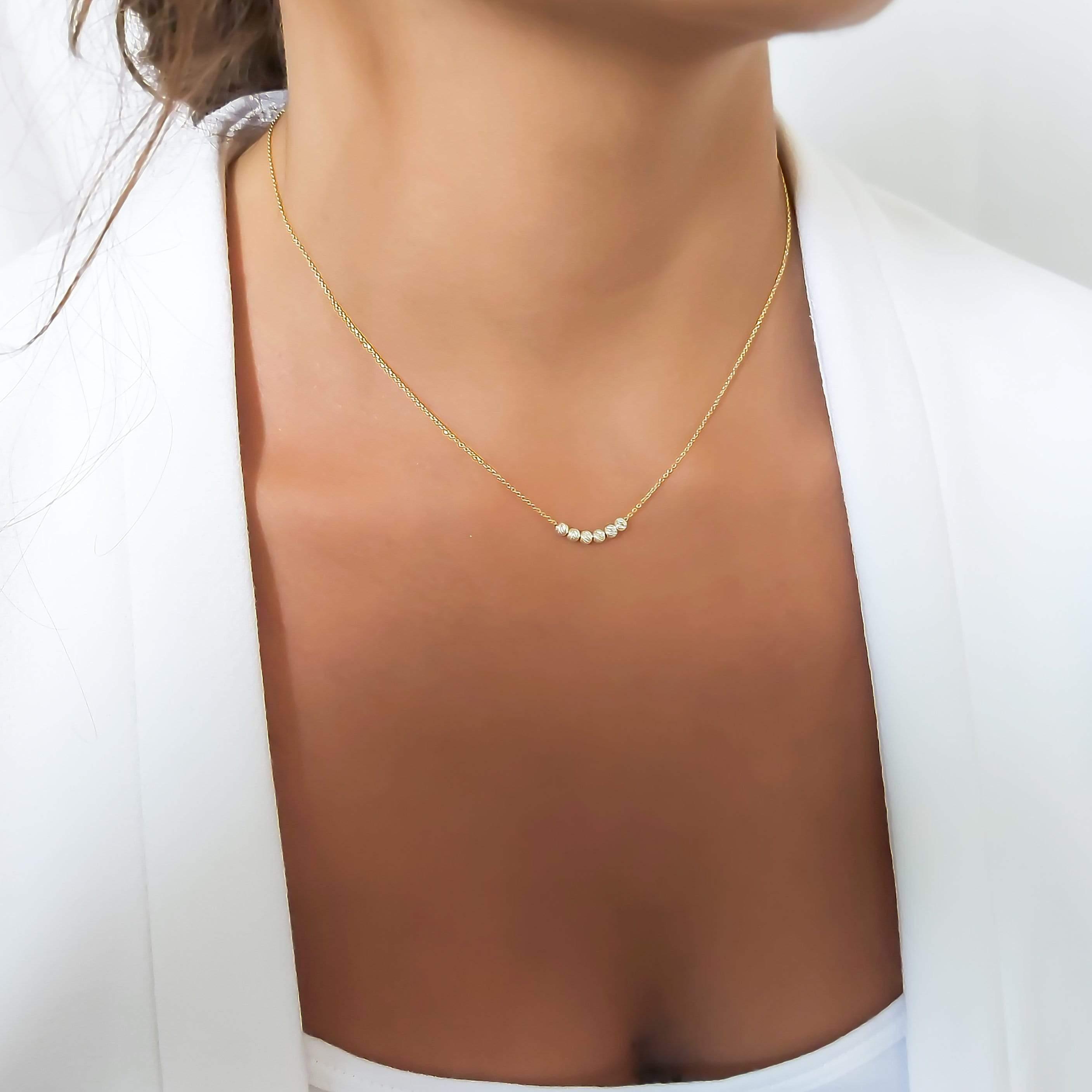 Dainty gold beaded necklace store